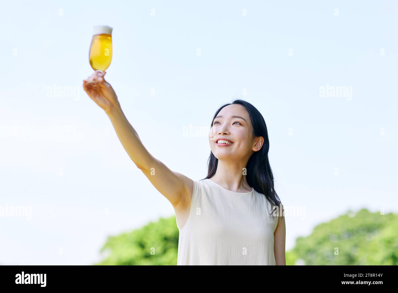 Young Japanese woman enjoying a cold beer outside Stock Photo - Alamy