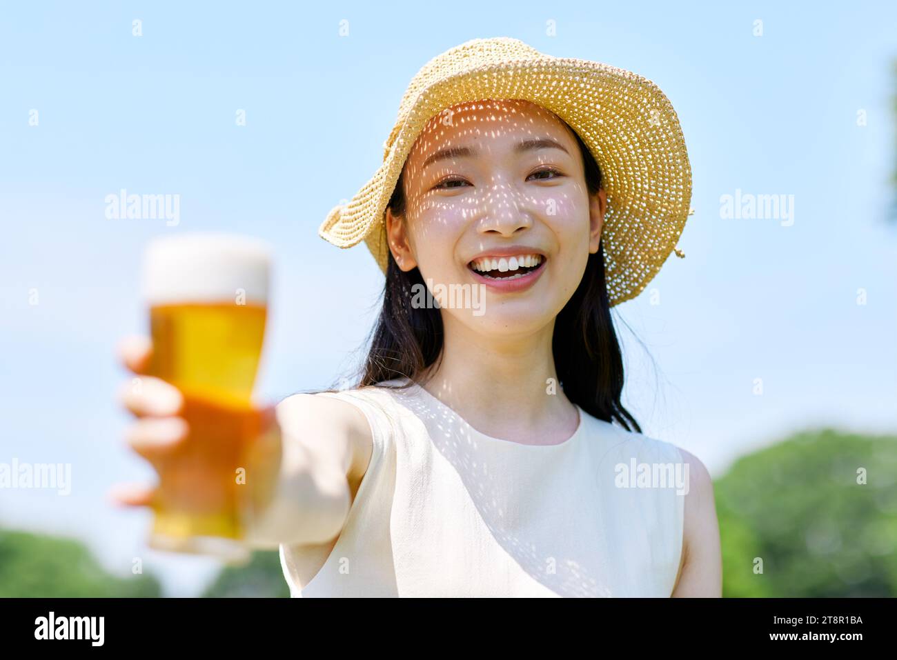 Young Japanese woman enjoying a cold beer outside Stock Photo - Alamy