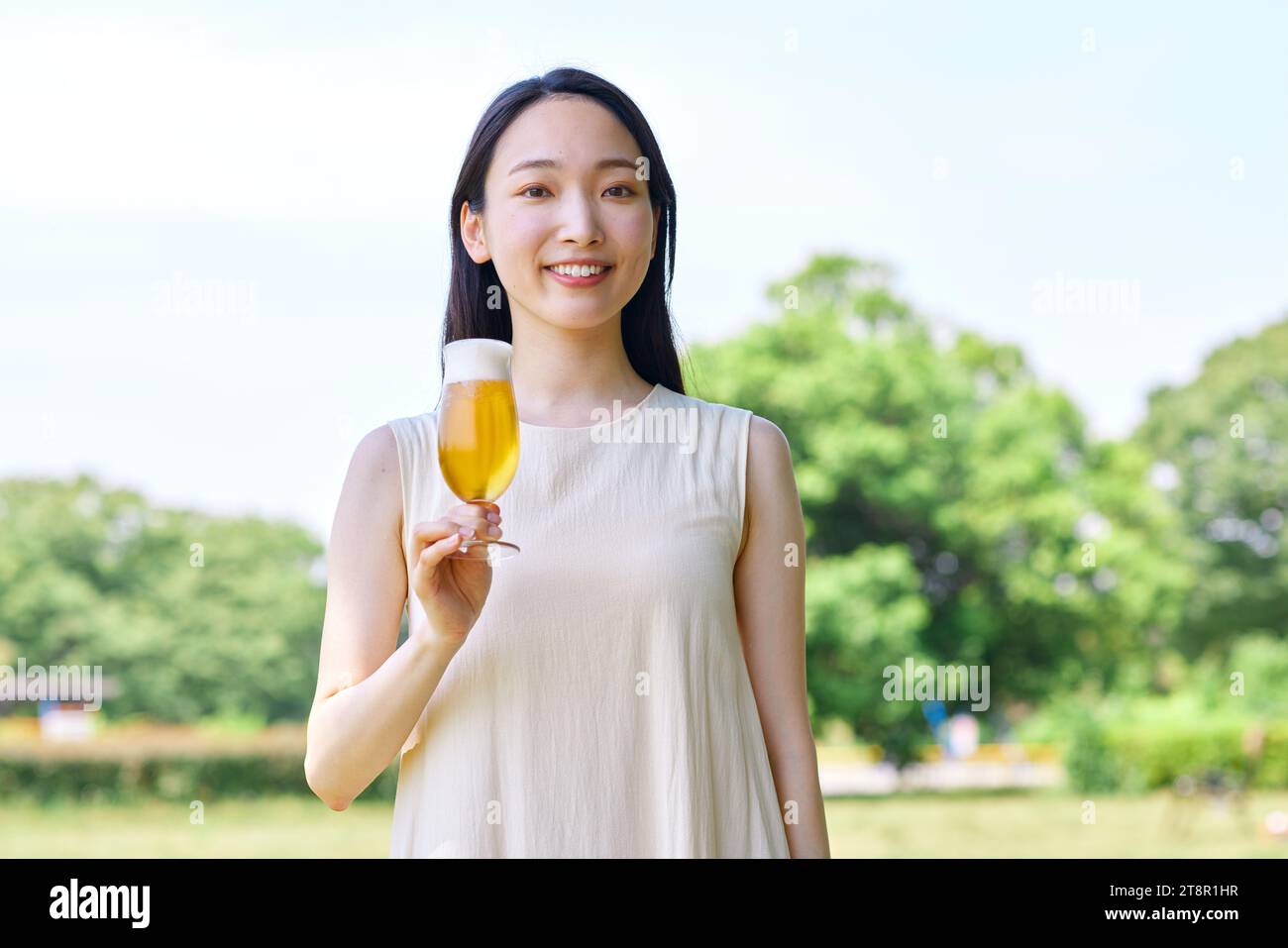 Young Japanese woman enjoying a cold beer outside Stock Photo - Alamy