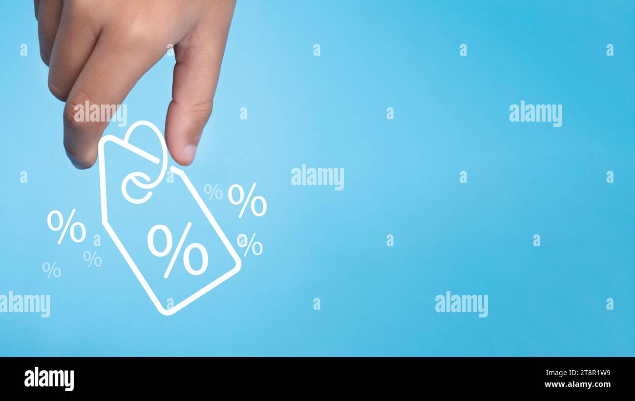 Human hand holds discount percentage sign icon on light blue background ...