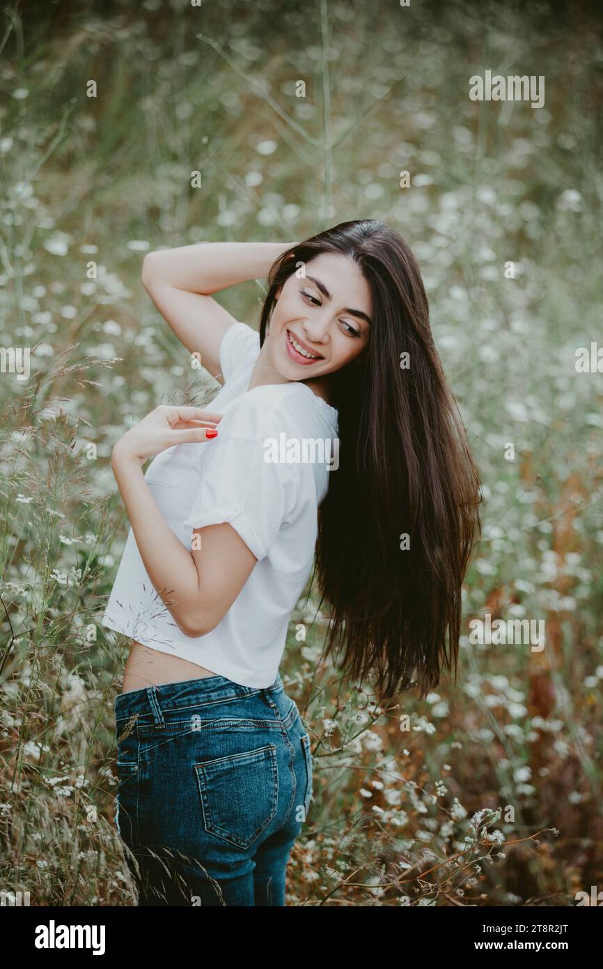 Women smiling looking over shoulder hi-res stock photography and images ...