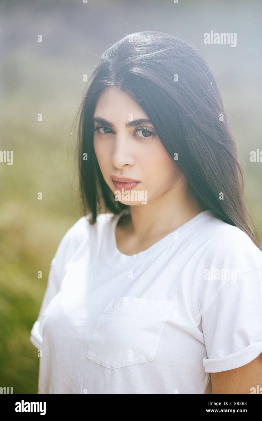 Beautiful shy girl looking at camera outdoors Stock Photo - Alamy