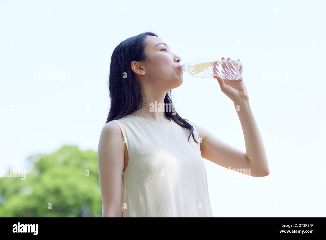 Young Japanese woman drinking water outside Stock Photo - Alamy