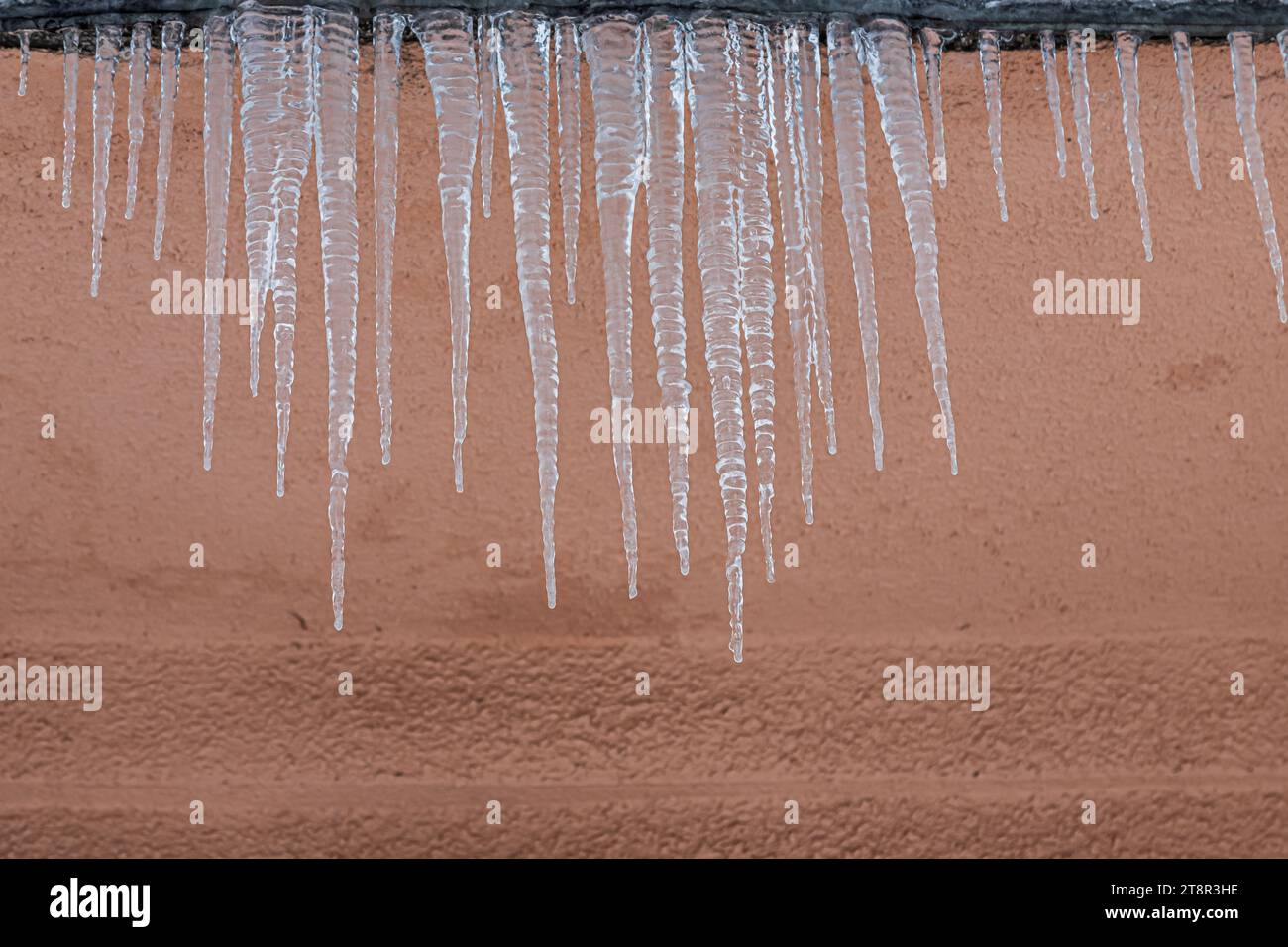 Icicles on the roof. The drain is full of snow and ice. Icicles falling ...