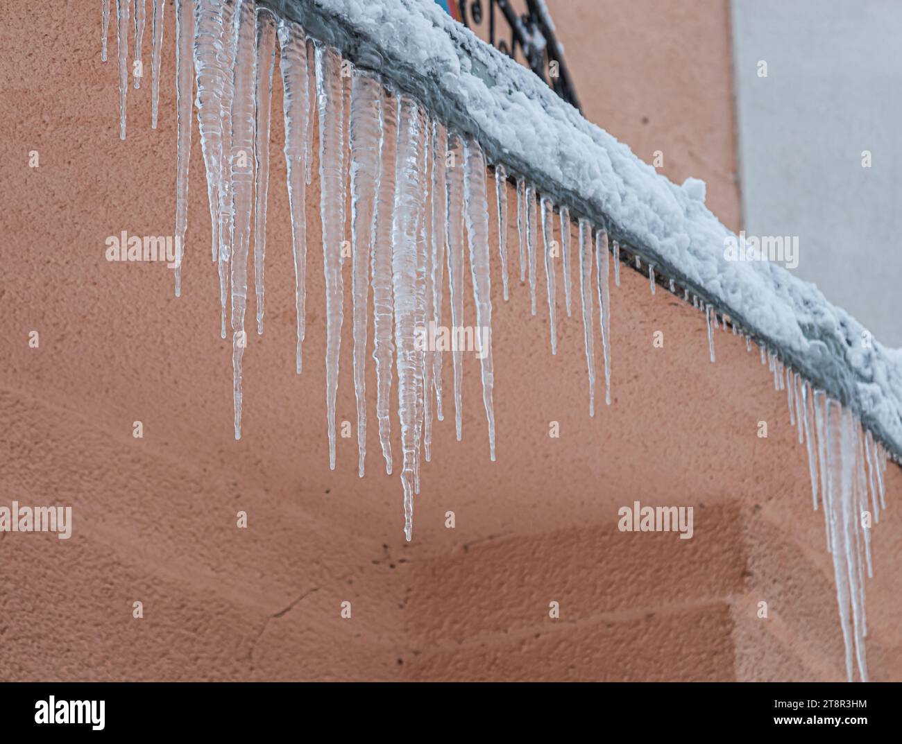 Icicles on the roof. The drain is full of snow and ice. Icicles falling ...