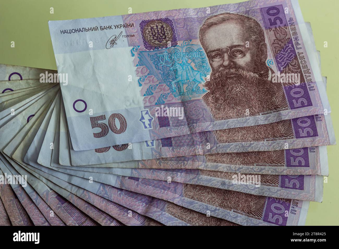 Ukrainian paper money is laid out on a blue background. 50 hryvnia ...