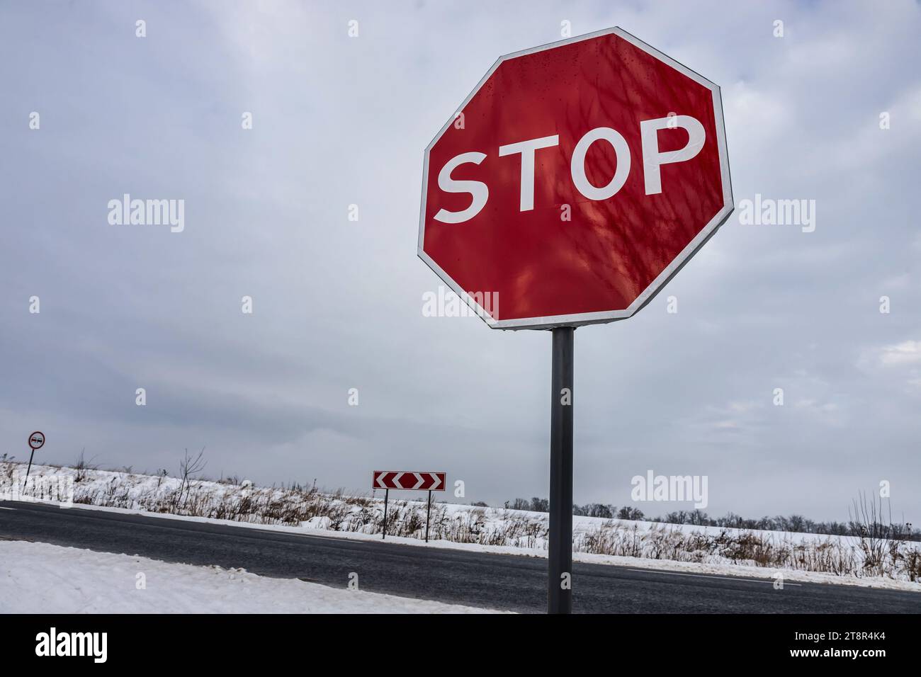 Stop road sign in snowy day in winter Stock Photo - Alamy