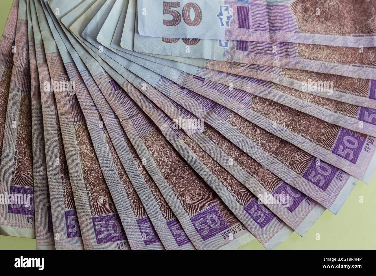 Ukrainian paper money is laid out on a blue background. 50 hryvnia ...