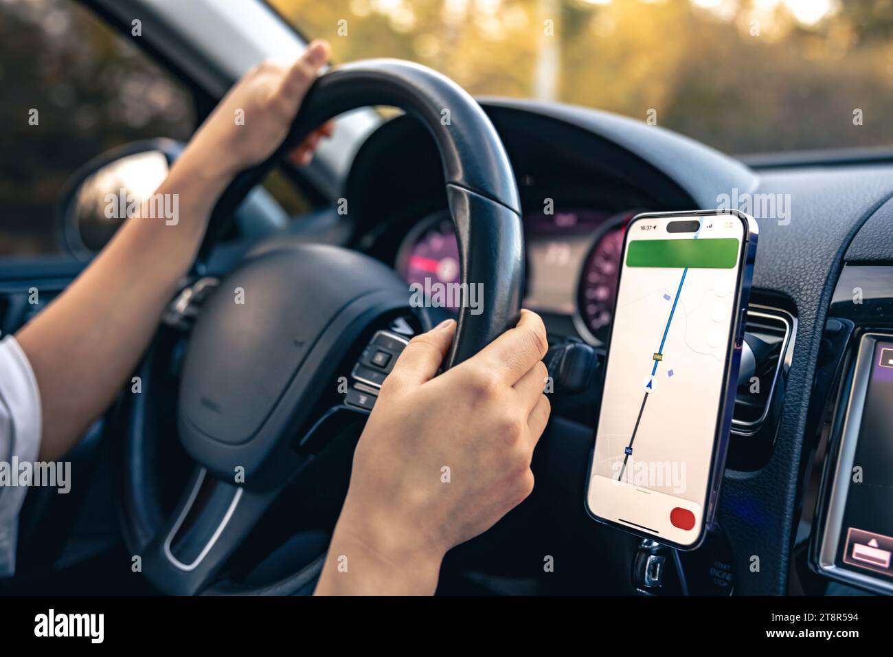 Woman using navigation app on smartphone while driving a car Stock ...