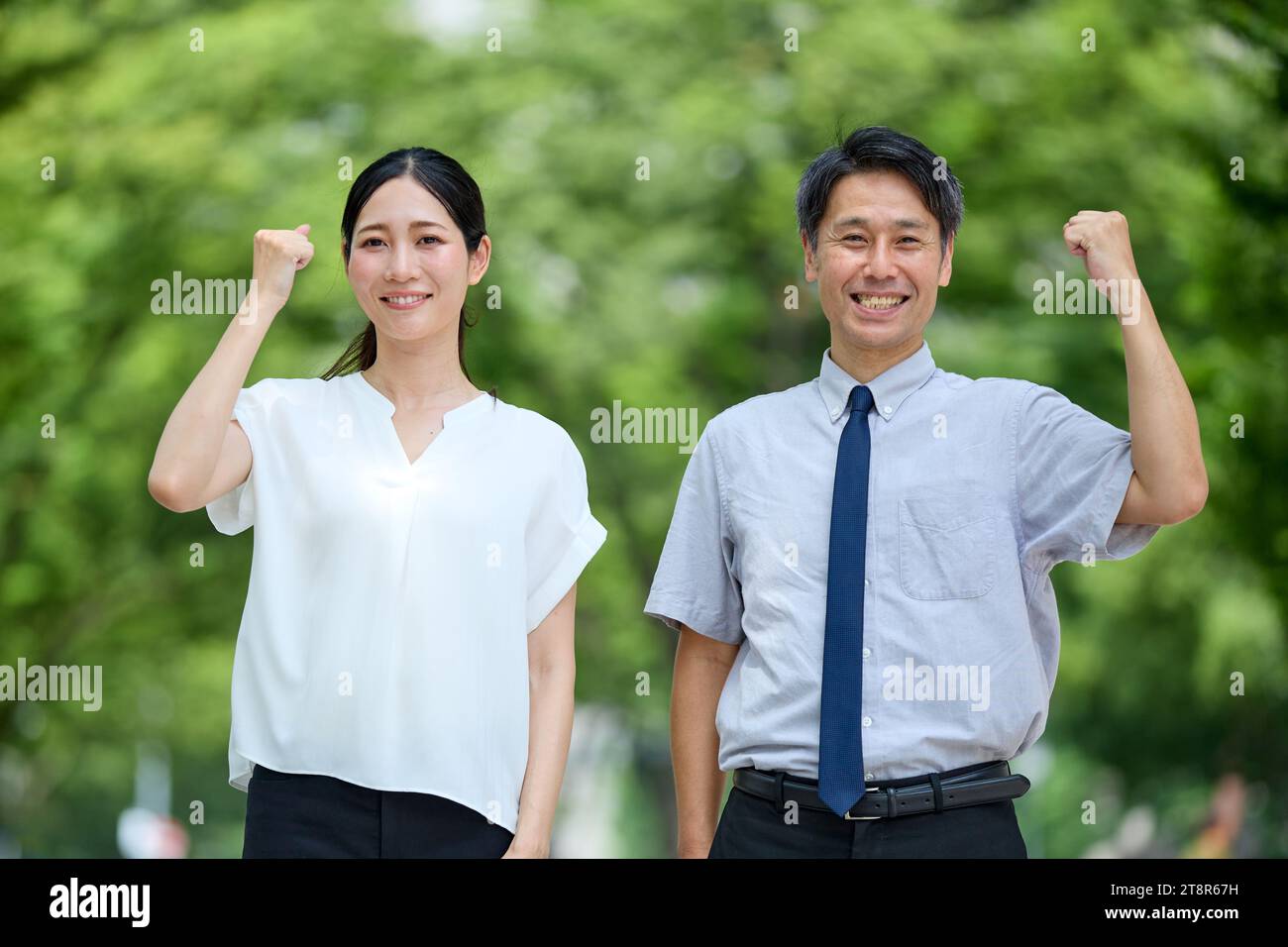 Japanese man and woman portrait in a city park Stock Photo - Alamy
