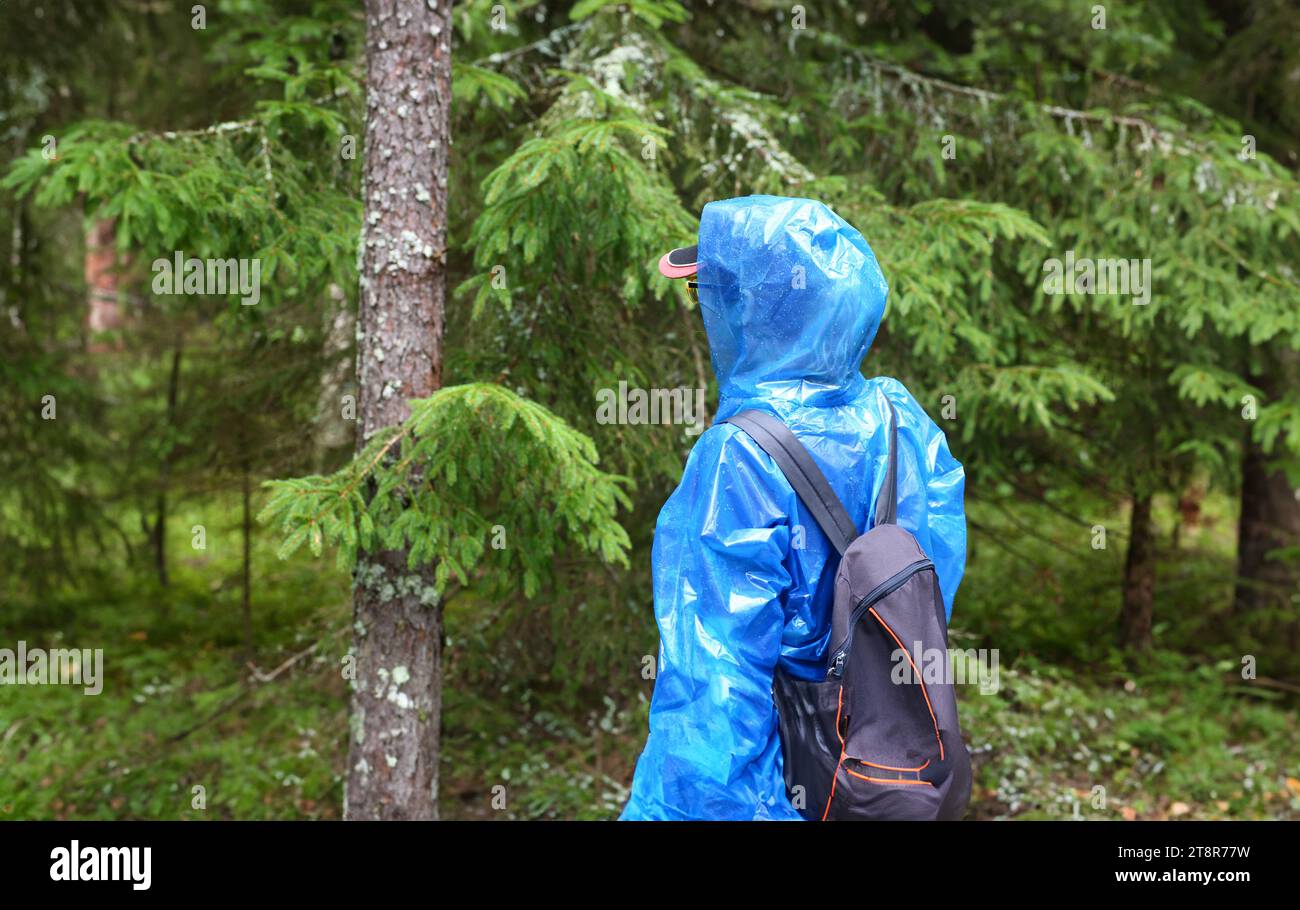 Woman in blue raincoat backpack hi-res stock photography and images - Alamy