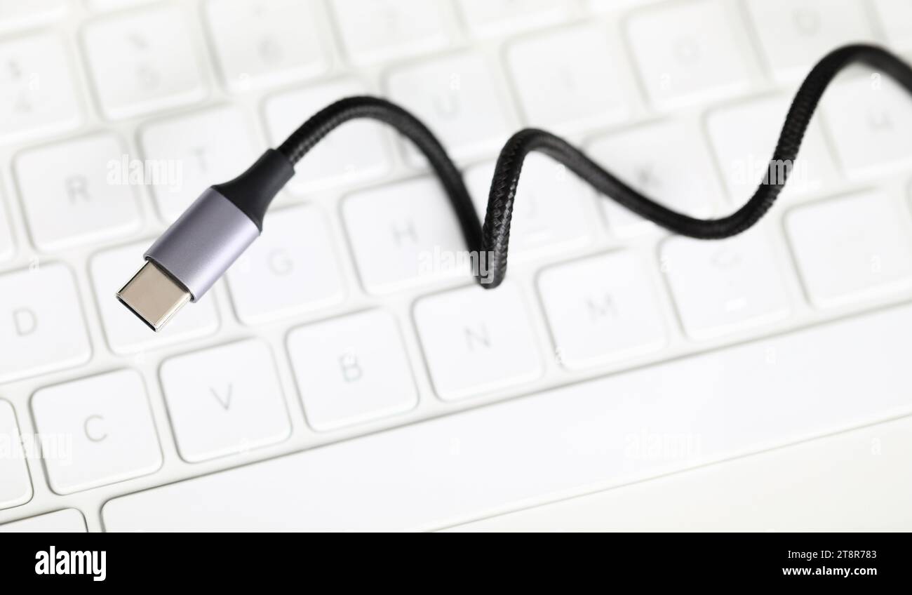 Usb type c cable against laptop keyboard background Stock Photo - Alamy
