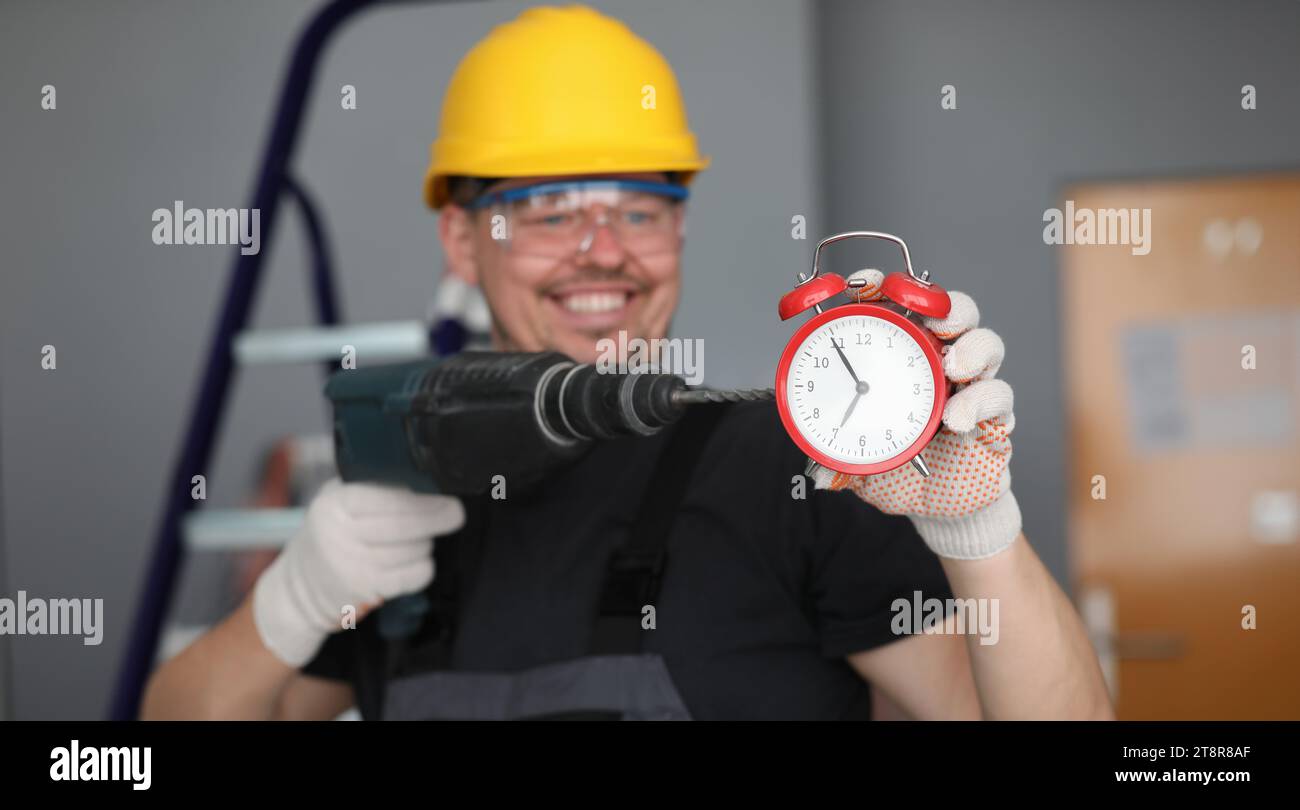 Construction worker holding clock hi-res stock photography and images ...