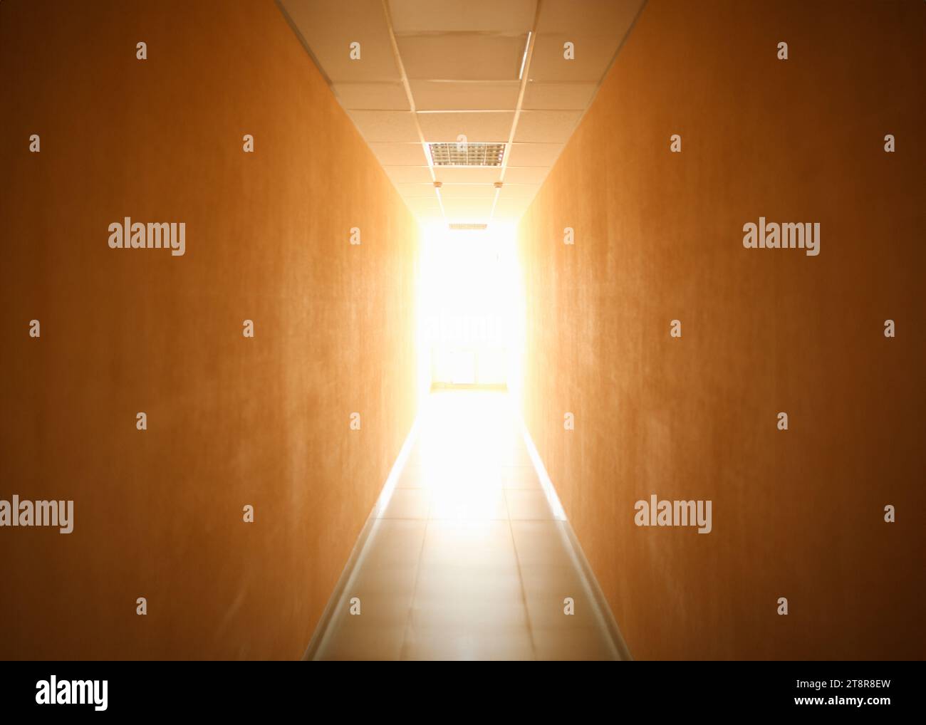 Long narrow tunnel with light in the end Stock Photo - Alamy