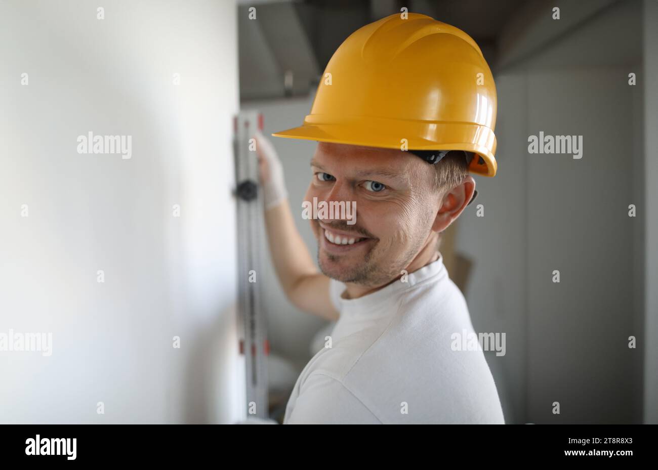 Smiling worker wearing helmet Stock Photo - Alamy