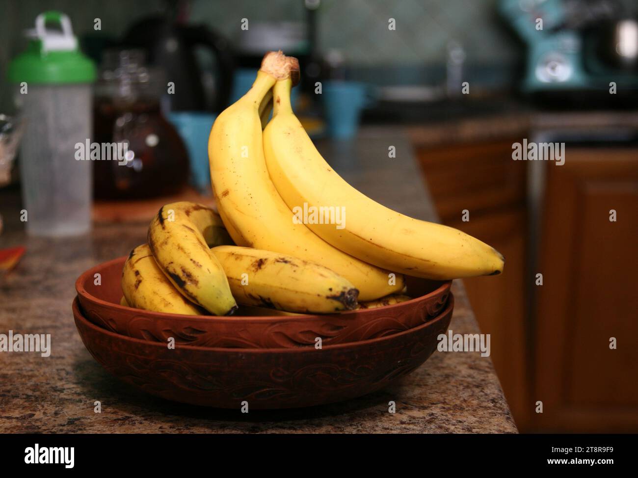 A bunch of bananas lying on a solid wooden table. Sweet ripe bananas ...
