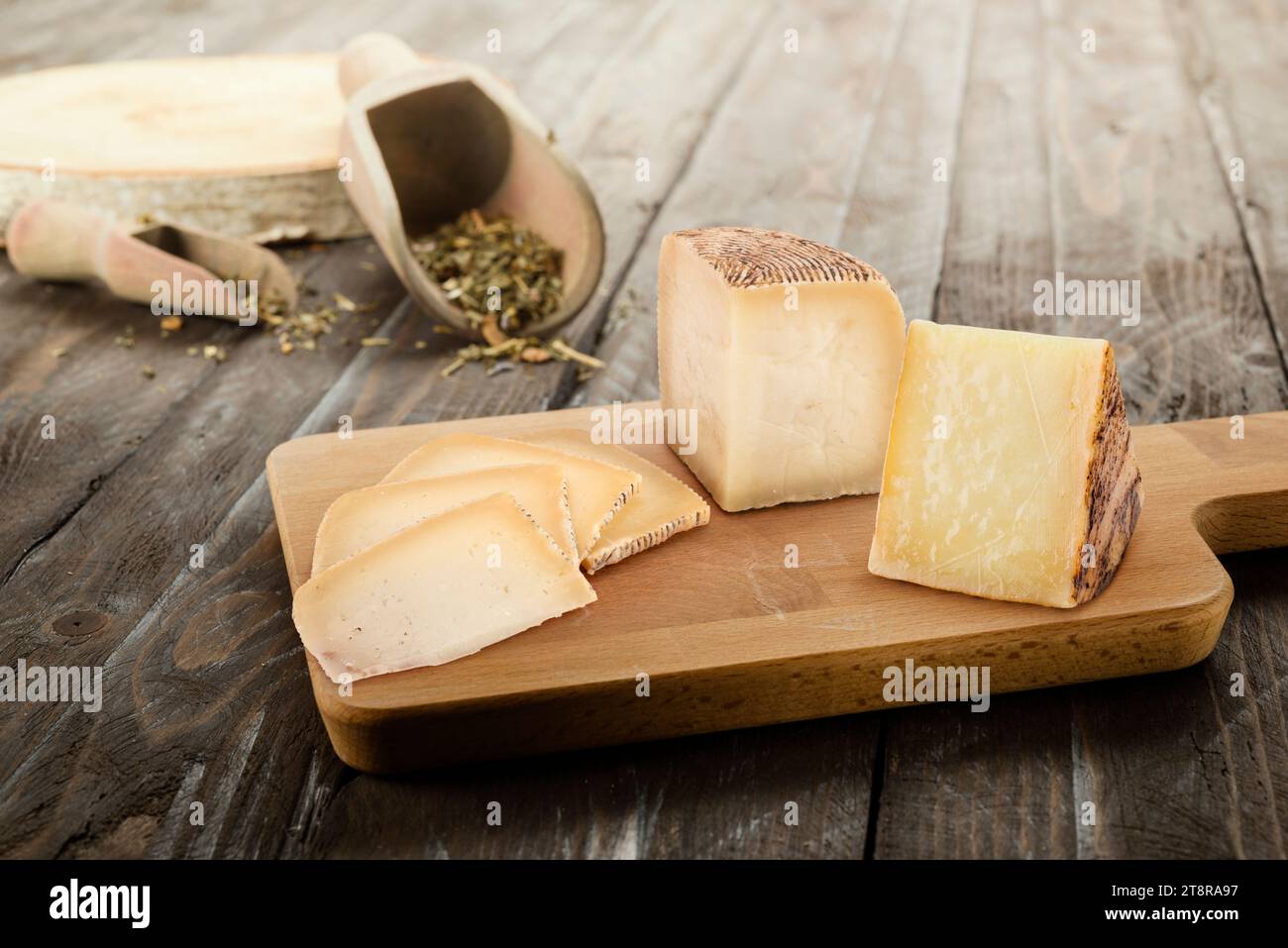 Goat cheese chunks and slices on wooden board Stock Photo - Alamy
