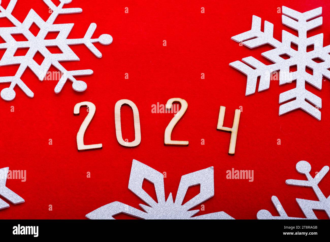 2024 wooden numbers on a red background Stock Photo - Alamy