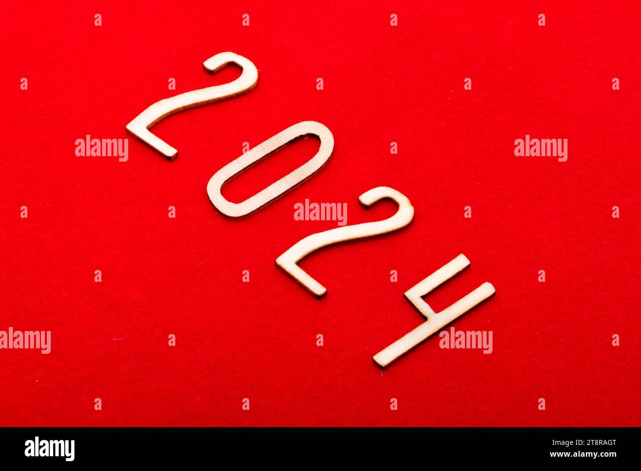 2024 wooden numbers on a red background Stock Photo - Alamy