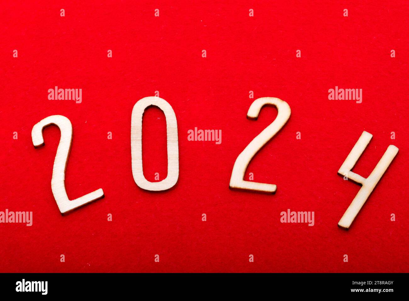 2024 wooden numbers on a red background Stock Photo - Alamy