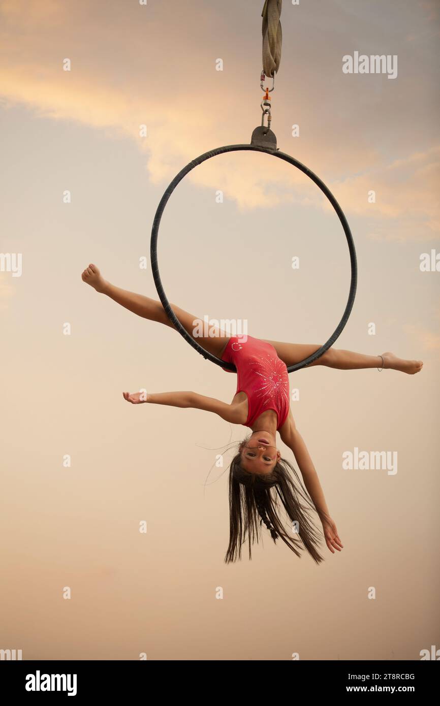 Little girl performing on the hoop outdoors Stock Photo - Alamy