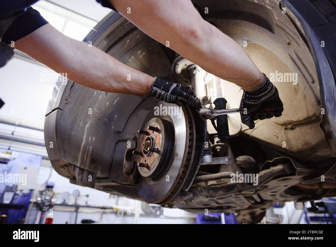 The hands of a mechanic hold a tool. Repair of the brake system of a ...
