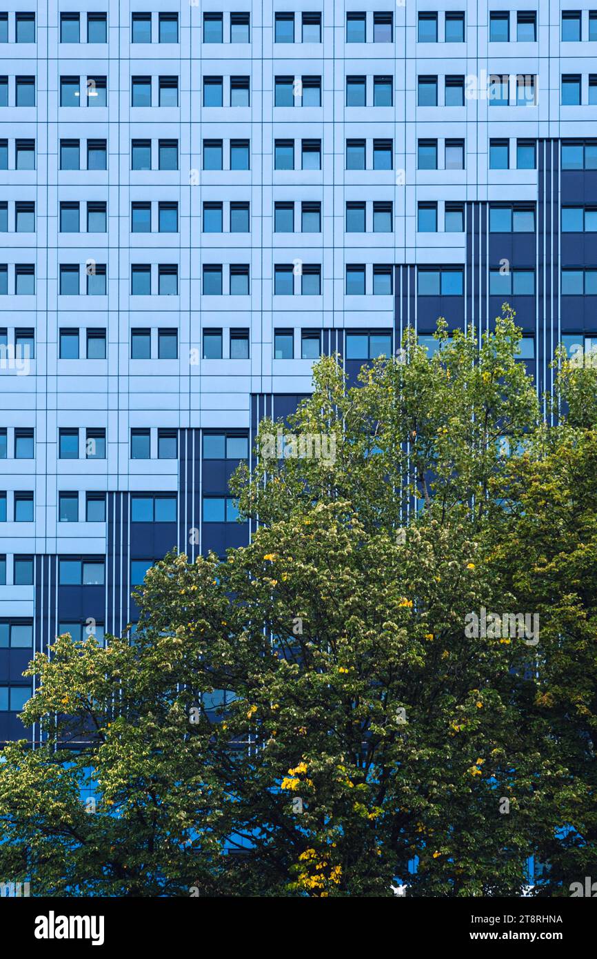 Modern building facade with rhythmic windows patterns against vibrant ...