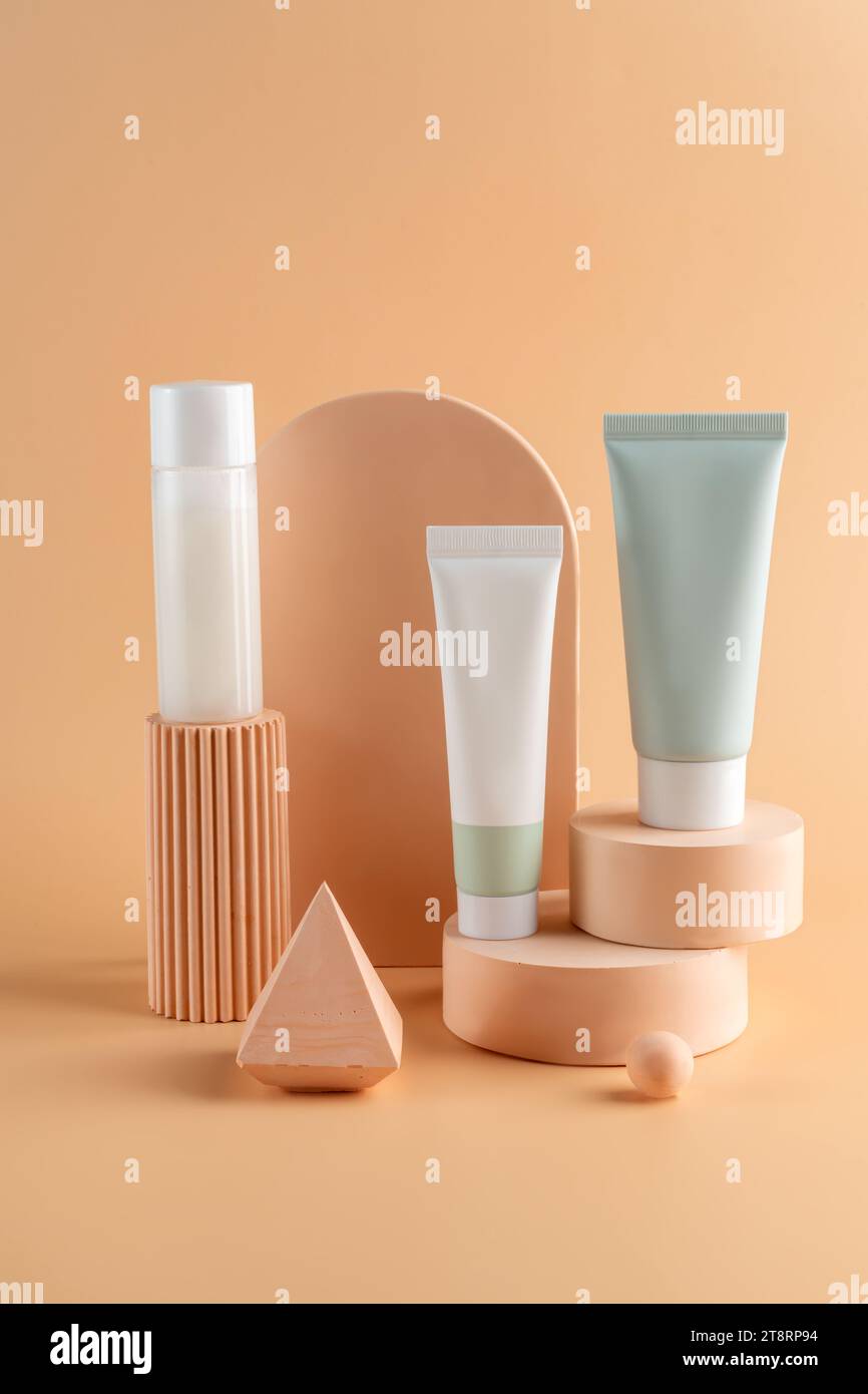 Group of white and green blank, unbranded cosmetic cream jars and tubes ...