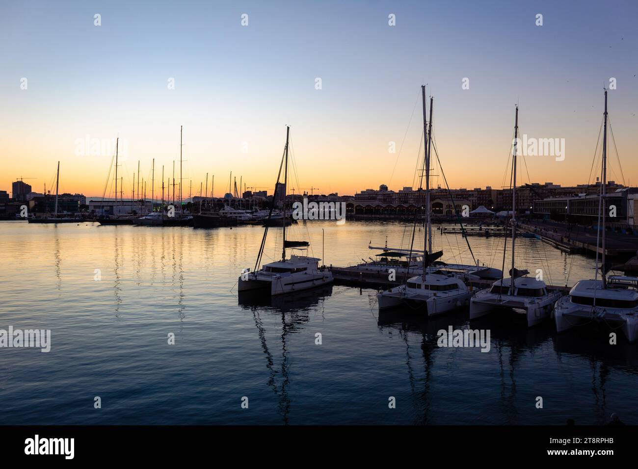 Sunset view of sailing ships docked in the port of Valencia - Spain ...