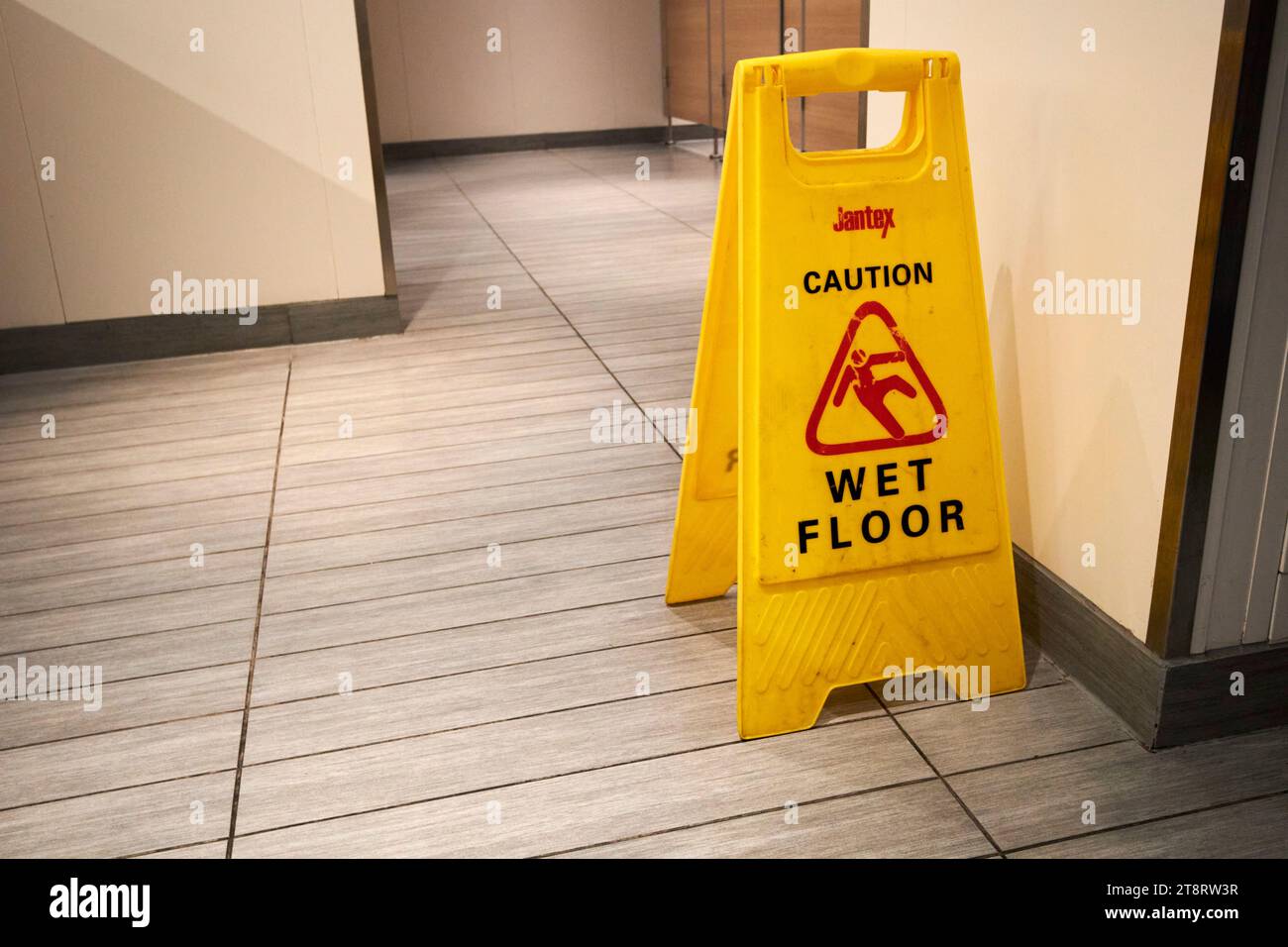 caution wet floor warning sign in a bathroom on board a stena line ...