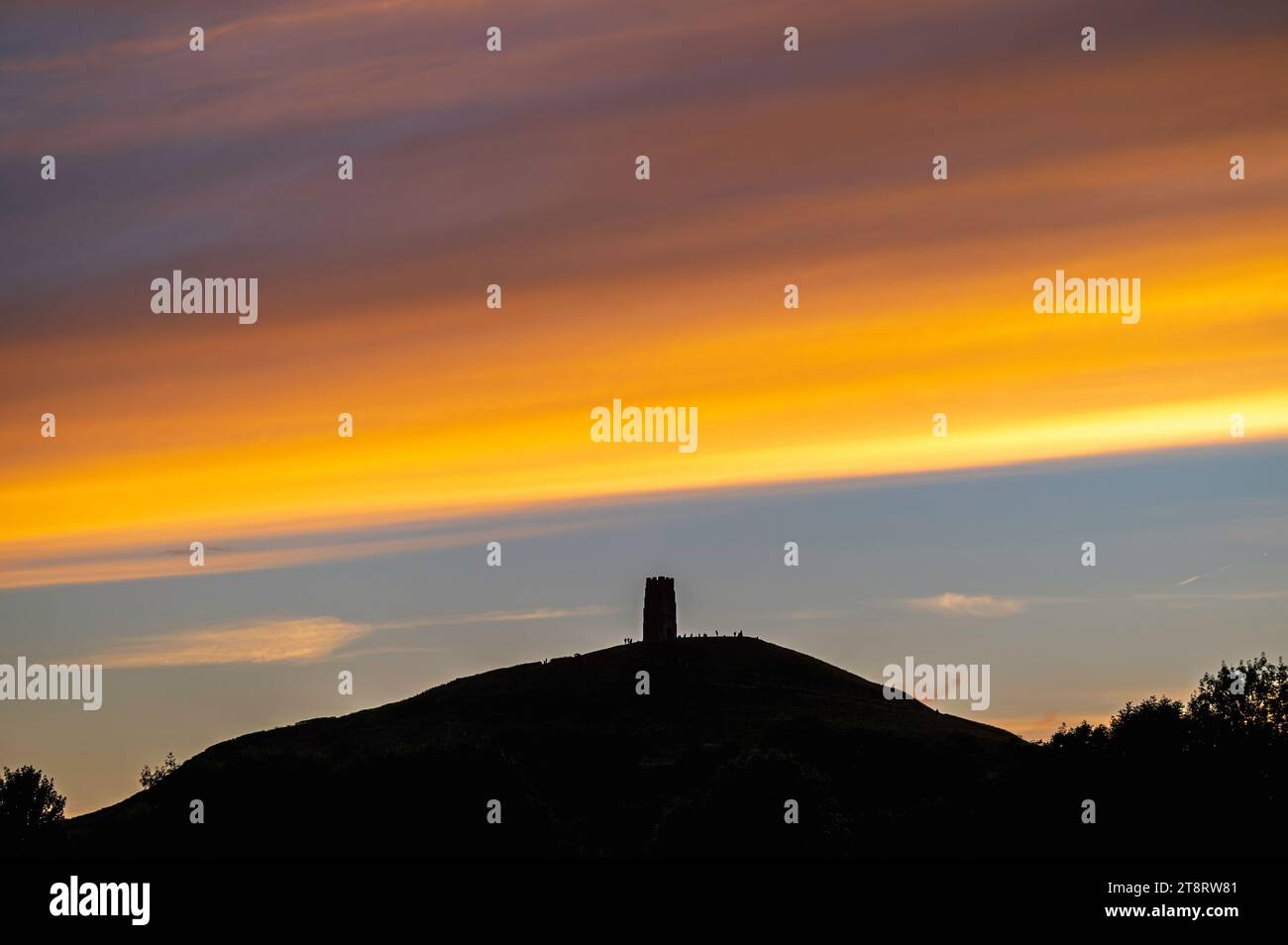 A colourful mid summer sunset at Glastonbury Tor, Glastonbury, Somerset ...