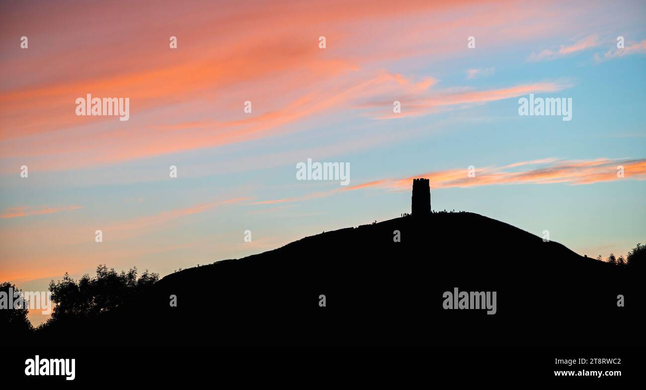 A colourful mid summer sunset at Glastonbury Tor, Glastonbury, Somerset ...