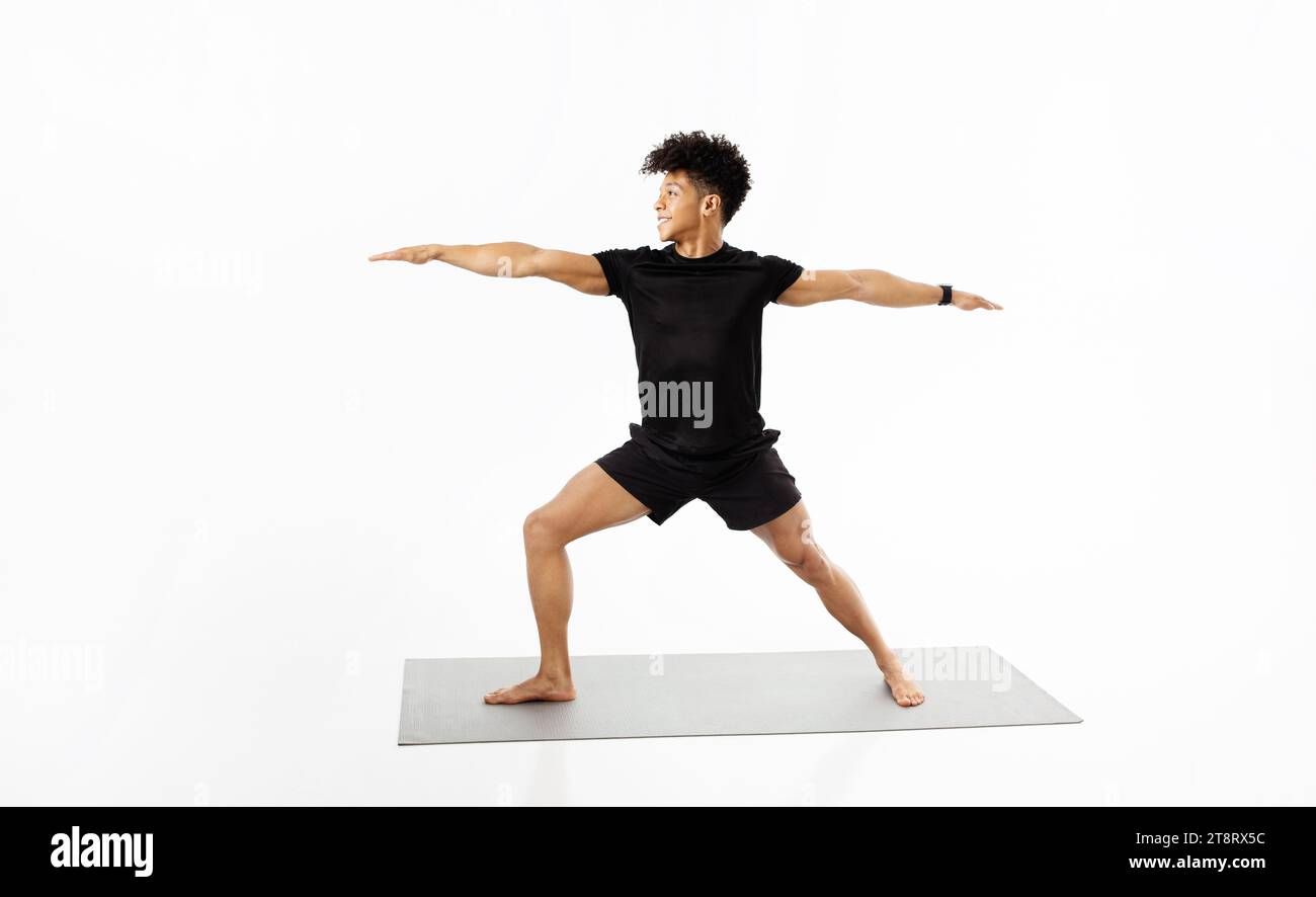 fitness instructor guy demonstrating yoga warrior pose over white ...