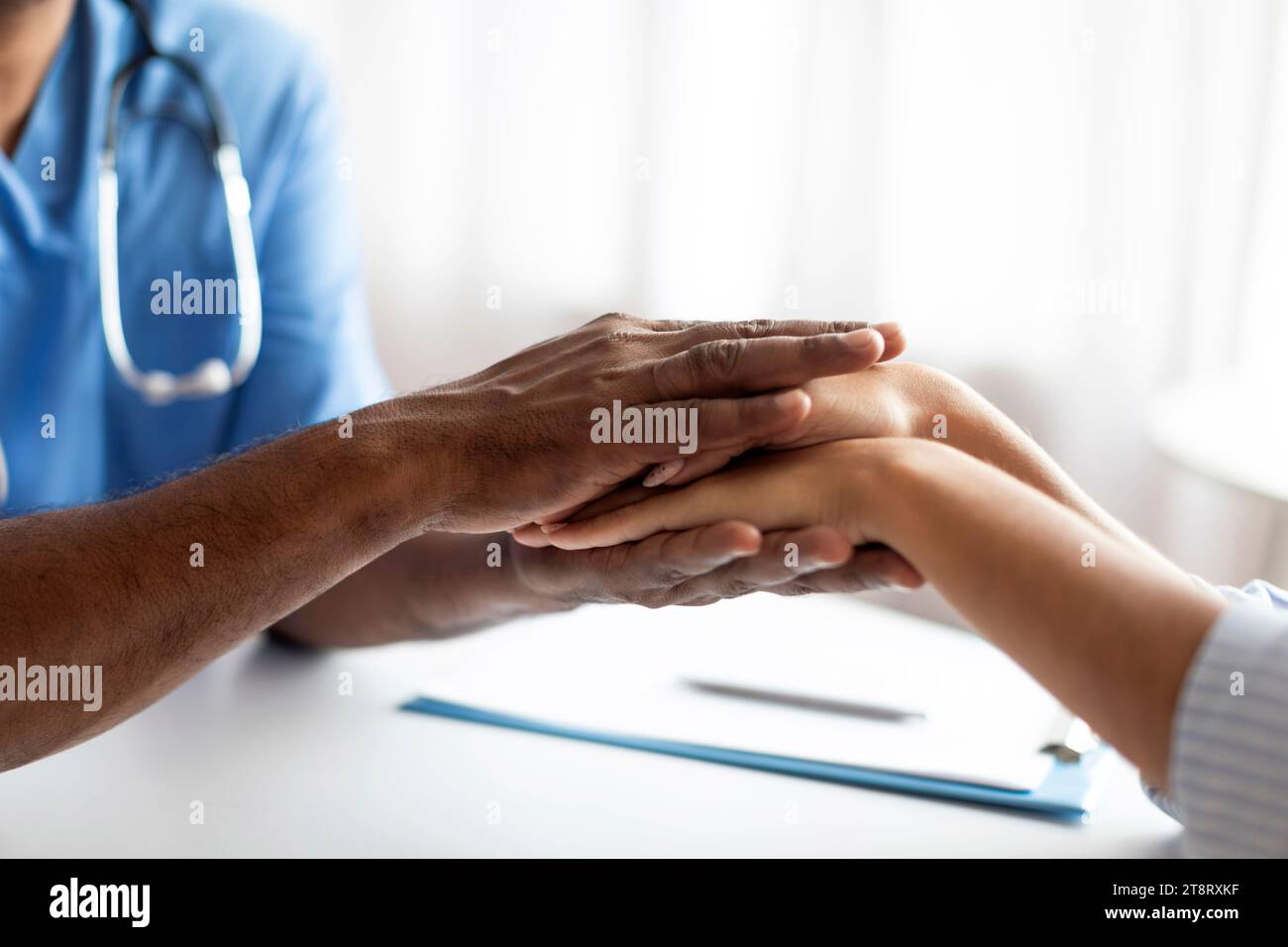 Medical Ethics Concept. Friendly male doctor holding female patient's ...