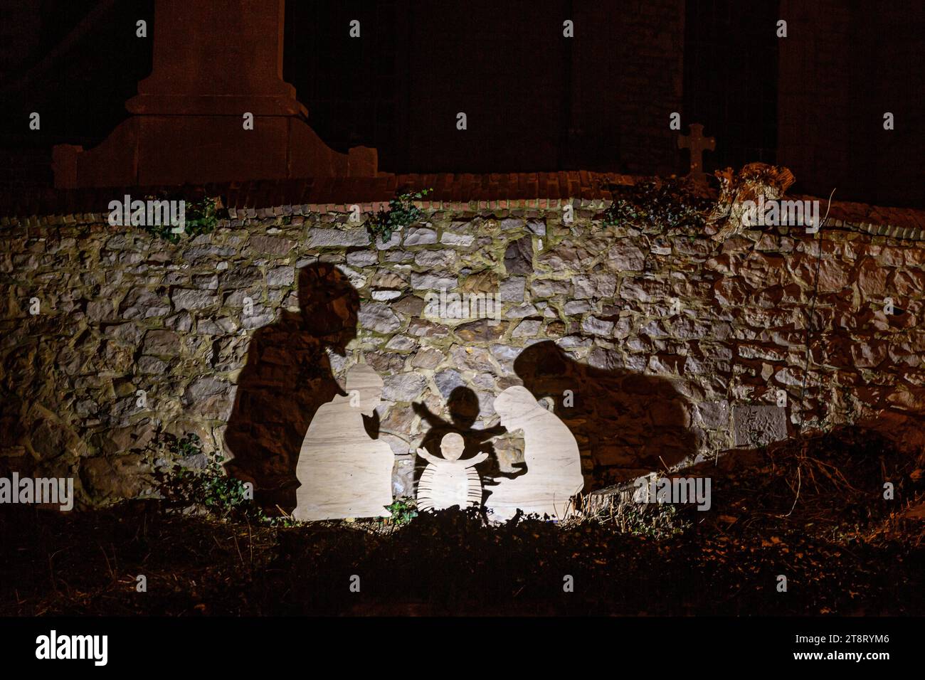 At the foot of a stone wall, a Christmas nativity scene made of ...