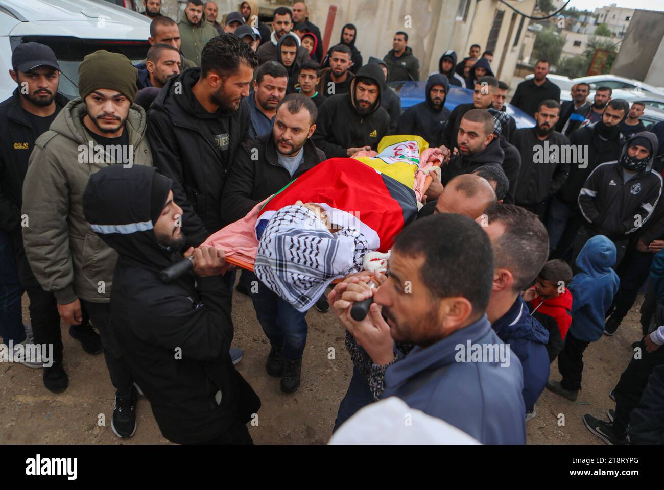 EDITORS NOTE: GRAPHIC CONTENT. Mourners carry the body of 21-year-old ...