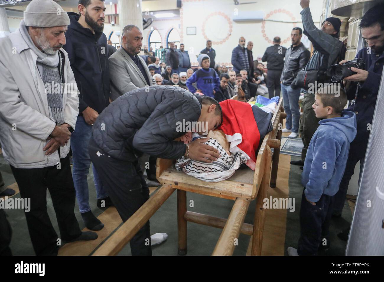 EDITORS NOTE: GRAPHIC CONTENT. Mourners carry the body of 21-year-old ...