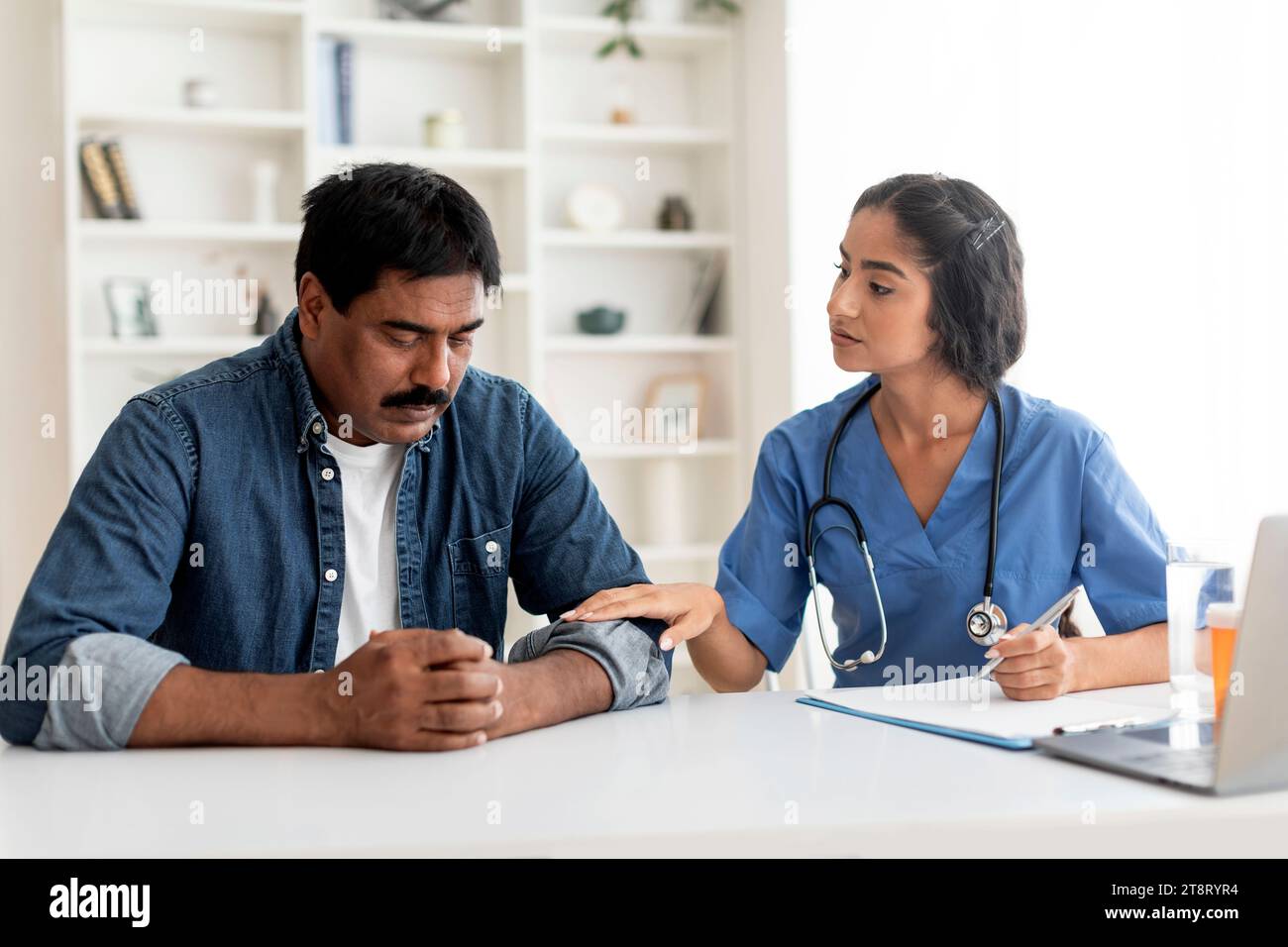Doctor comforting crying male patient hi-res stock photography and ...