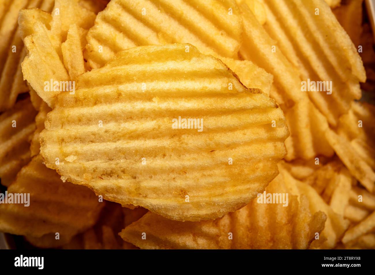 Close up snack food still life of crinkle cut crisps Stock Photo - Alamy