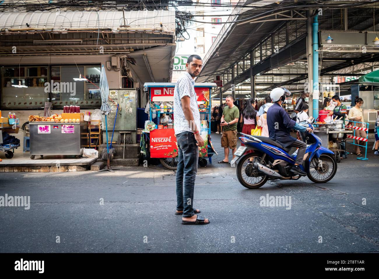 A market worker makes his way through Pratunam market Bangkok Thailand ...