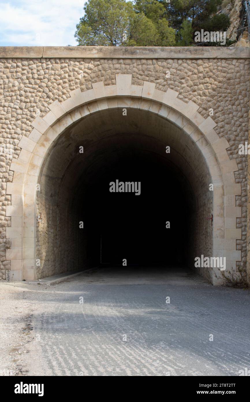 View of an entry of a long and dark tunnel Stock Photo - Alamy
