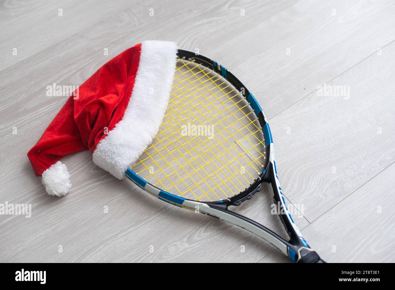 santa hat on tennis racket on white background Stock Photo - Alamy