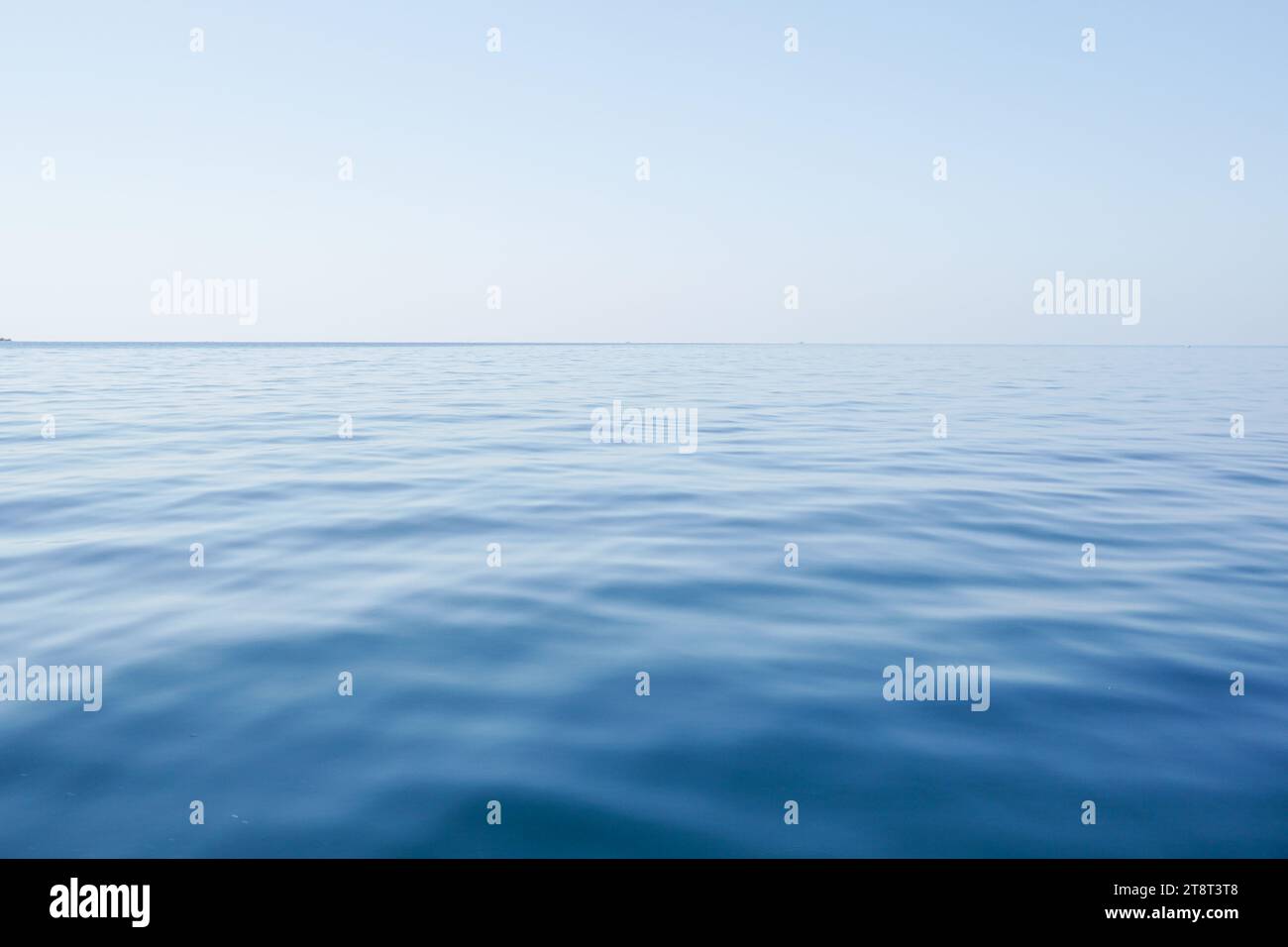 Horizontal line of calm sea surface on the day light. Sea on blue sky ...
