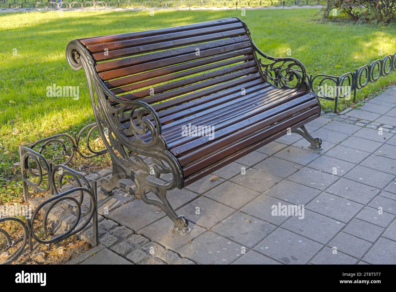 Old Style Cast Iron and Wood Bench in City Park Stock Photo - Alamy