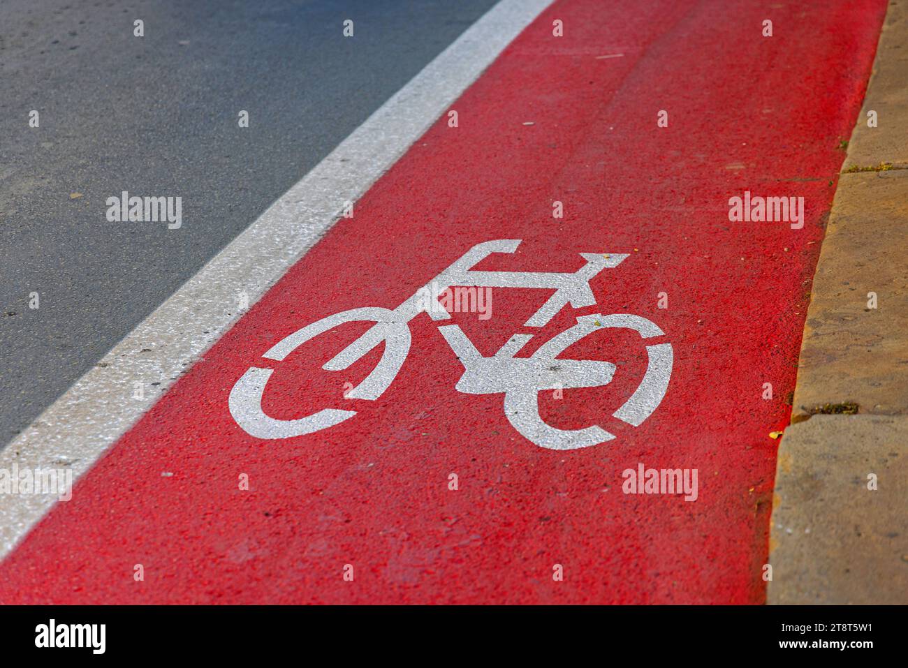 Painted Bright Red Bike Lane Stencil Sign at Street in City Stock Photo ...