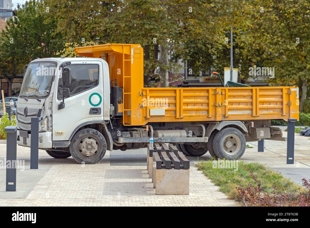 White Truck With Yellow Tipper in City Park Works Stock Photo - Alamy