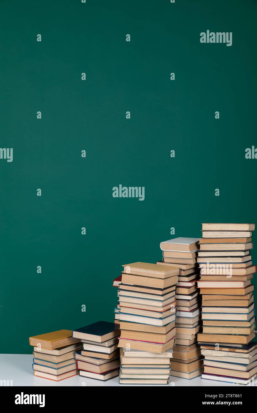 stack of books in the library on green background training education ...
