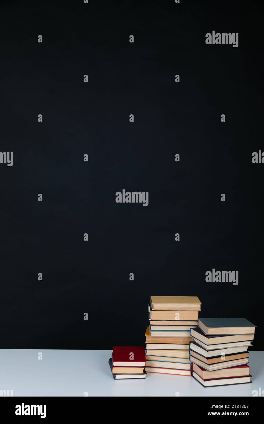 stack of books in the library on a black background training education ...