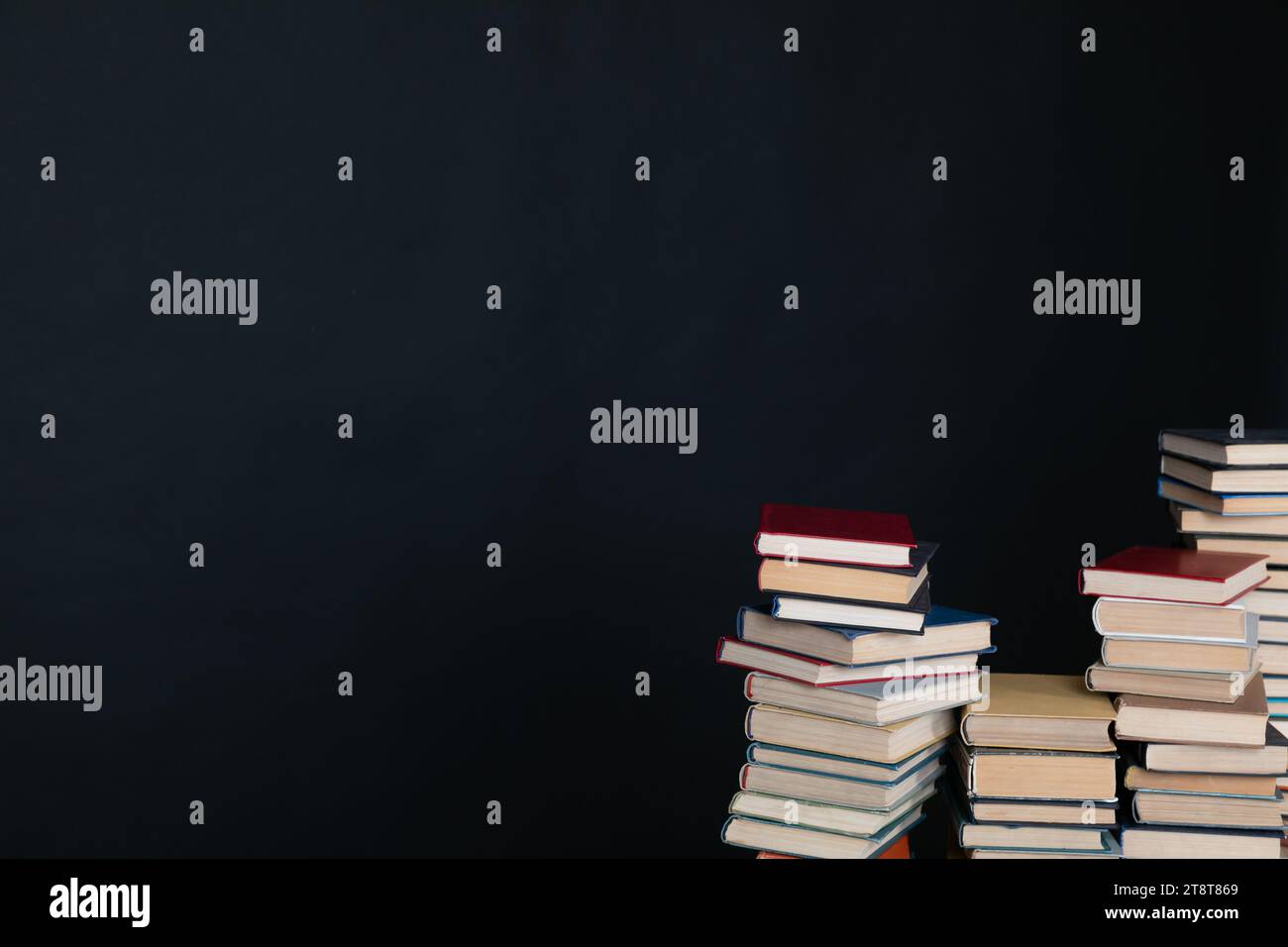 stack of books in the library on a black background training education ...