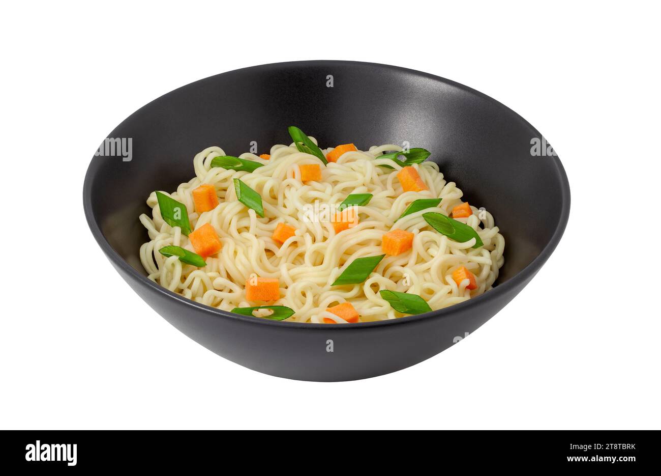 Instant noodles cooked with vegetables and herbs in a dark bowl ...